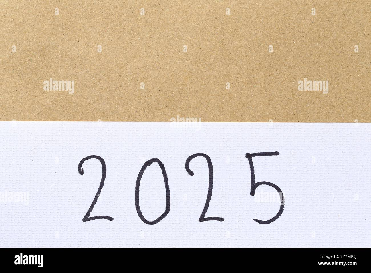 Numbers two thousand twenty-five are hand-written on white art paper ...