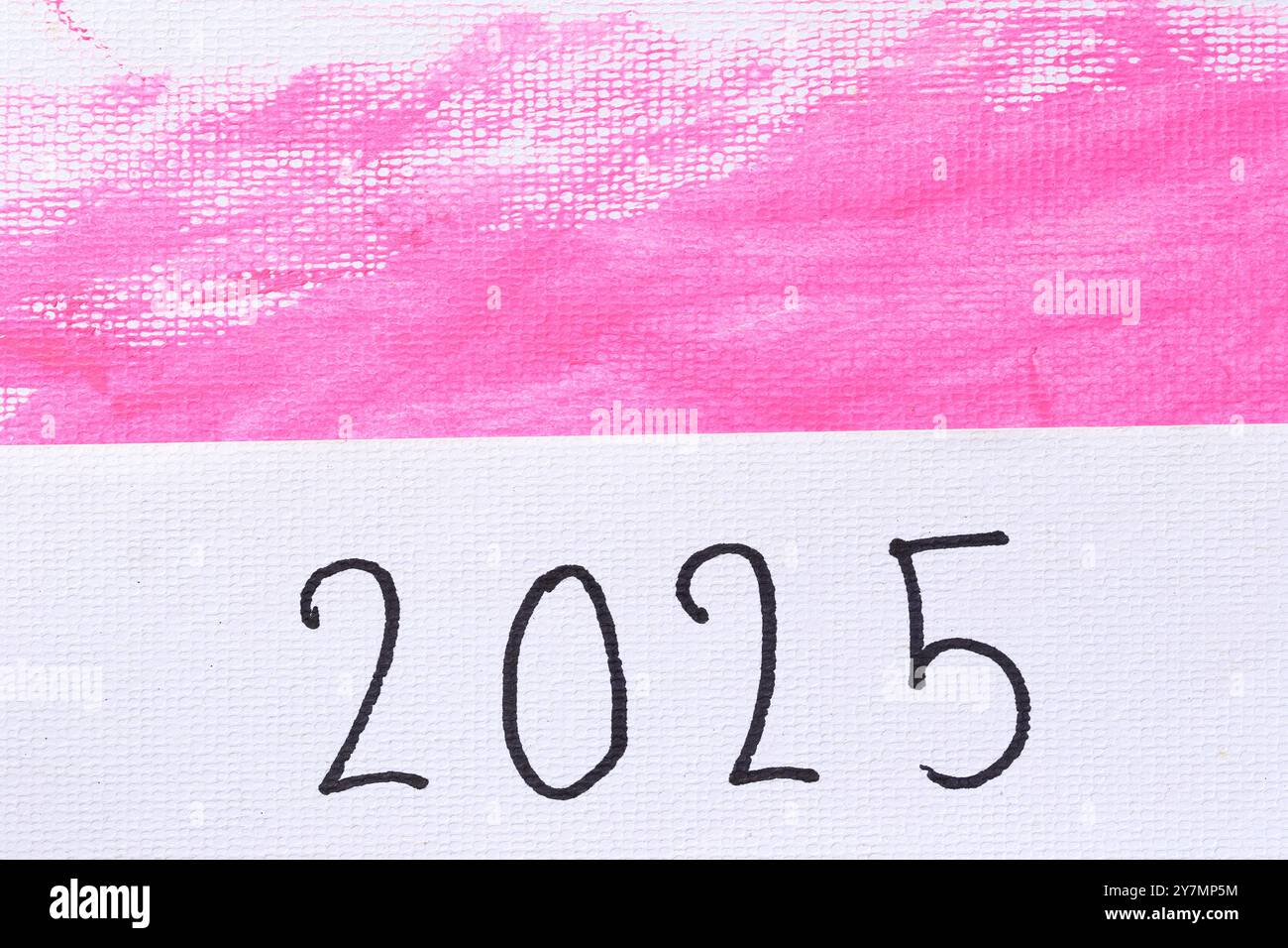 Numbers two thousand twenty-five are hand-written on white art paper ...