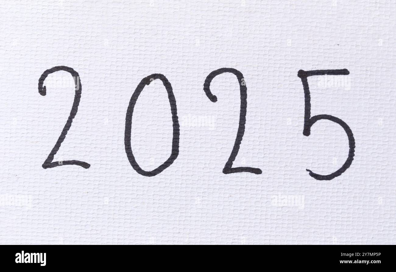 Numbers two thousand twenty-five are hand-written on white art paper ...