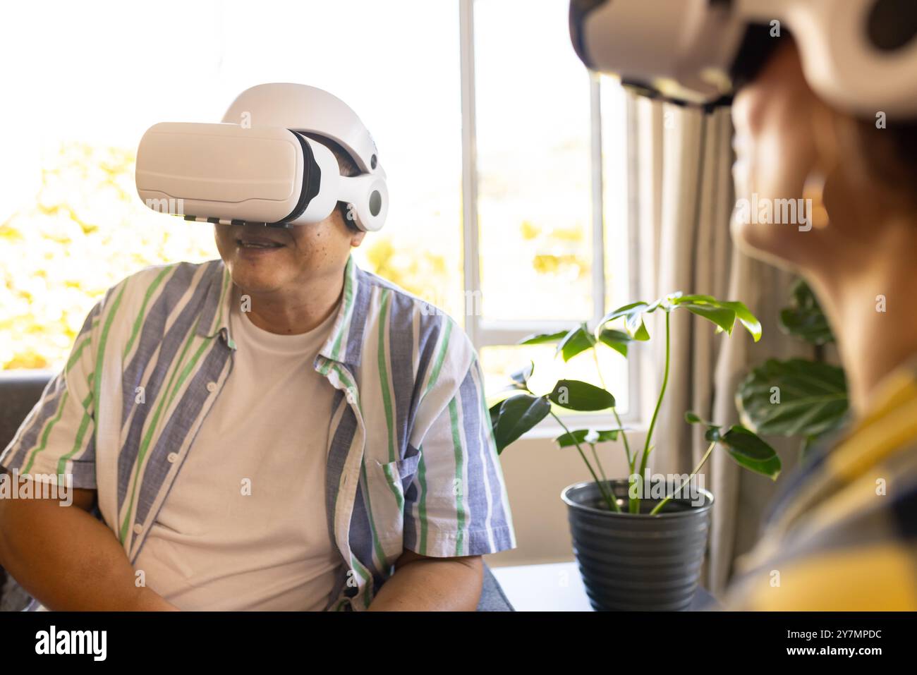 Using VR headsets, family members enjoying virtual reality experience ...