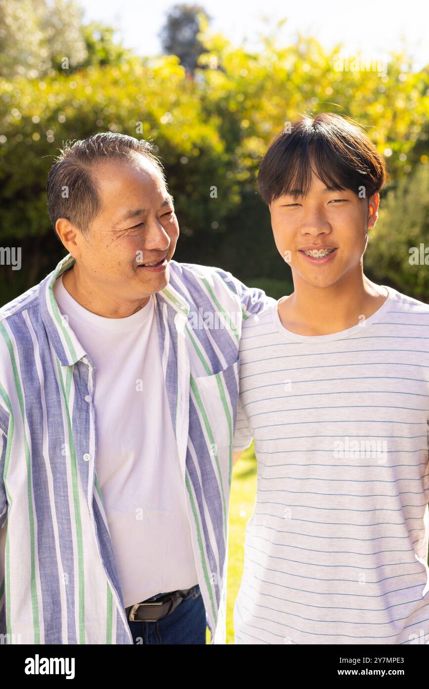 asian father and son smiling together, enjoying quality time outdoors ...