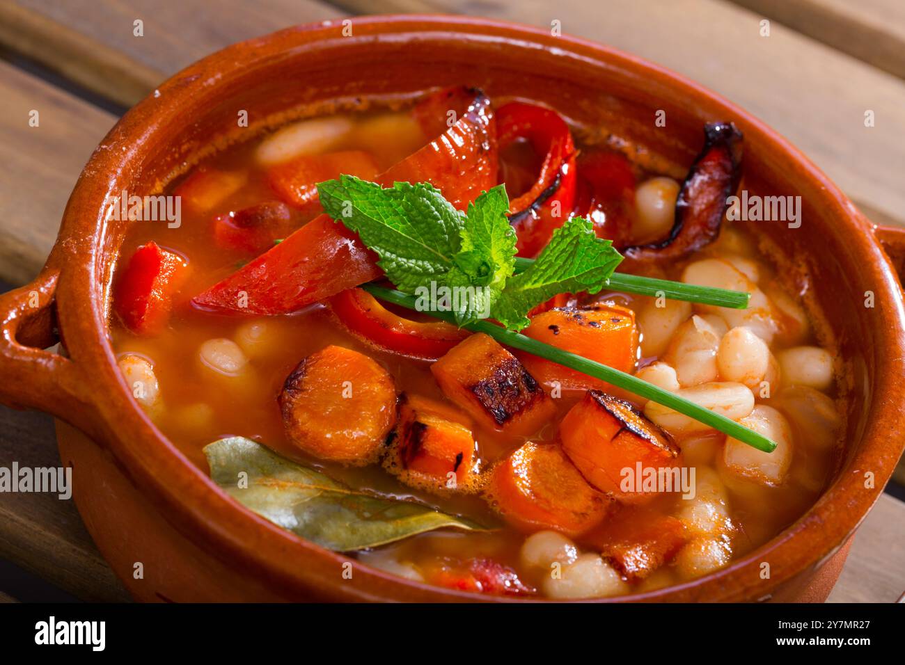 Bean's soup of broth cooked with boiled carrots, pepper and greens ...