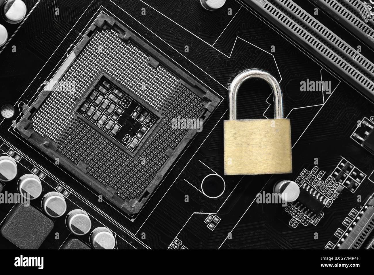 Golden master key in lock placed on a computer motherboard background ...