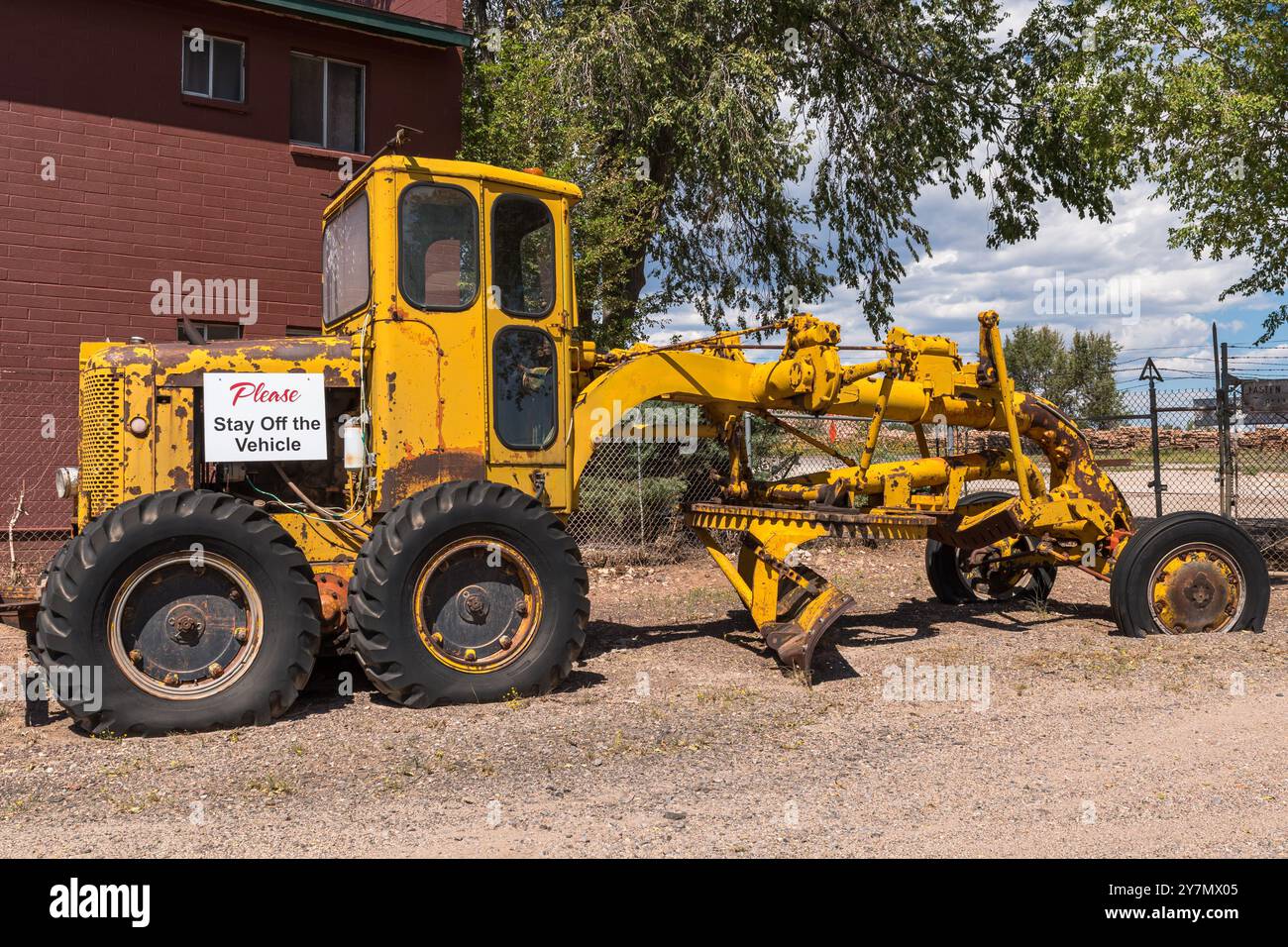 An old, parked road grader vehicle on display at the Ash Fork Museum in ...