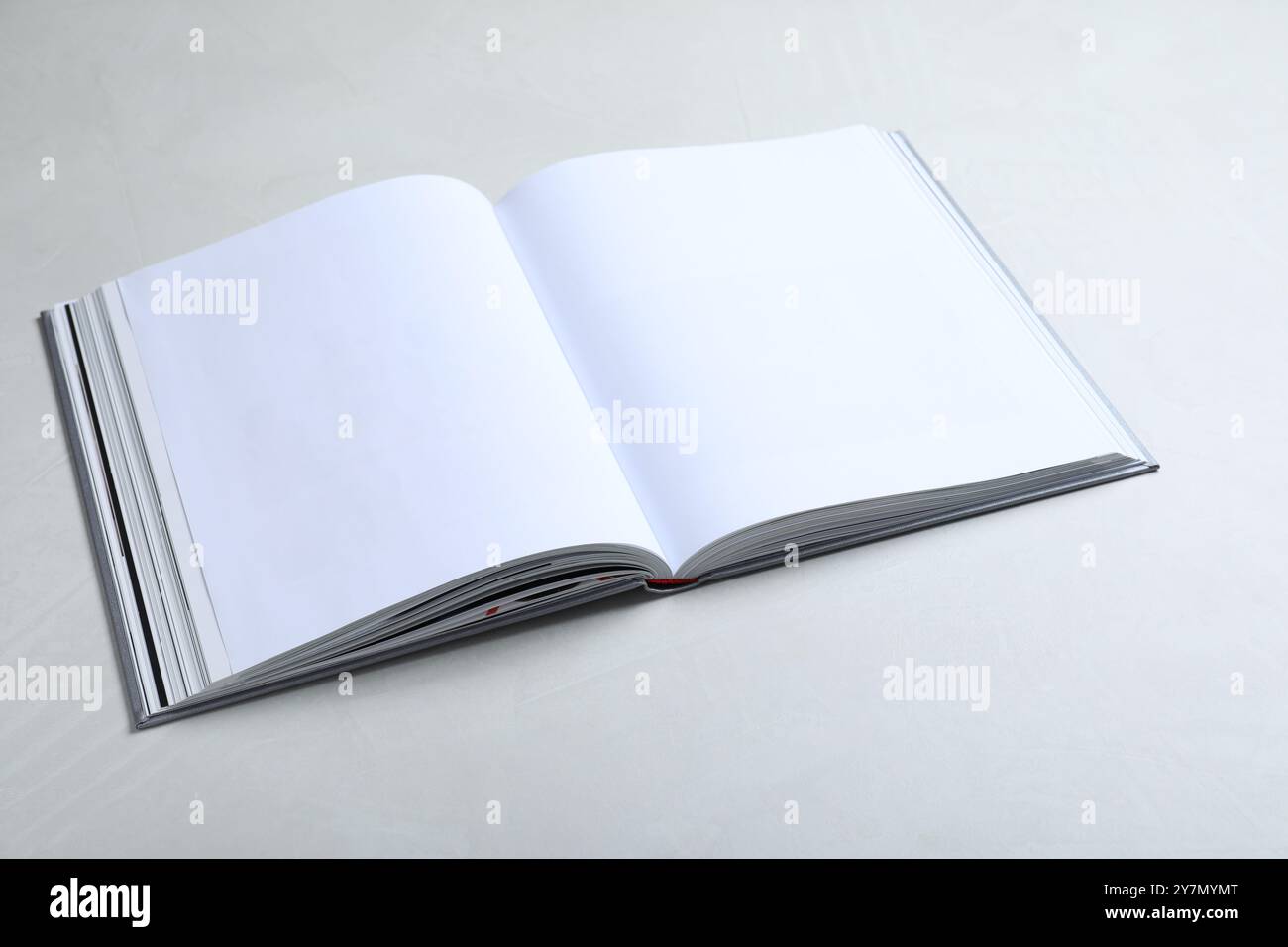 Open book with hard cover on light grey table Stock Photo - Alamy