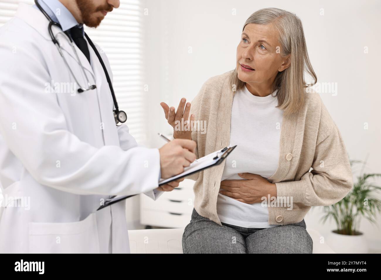Senior man abdominal pain doctor hi-res stock photography and images ...