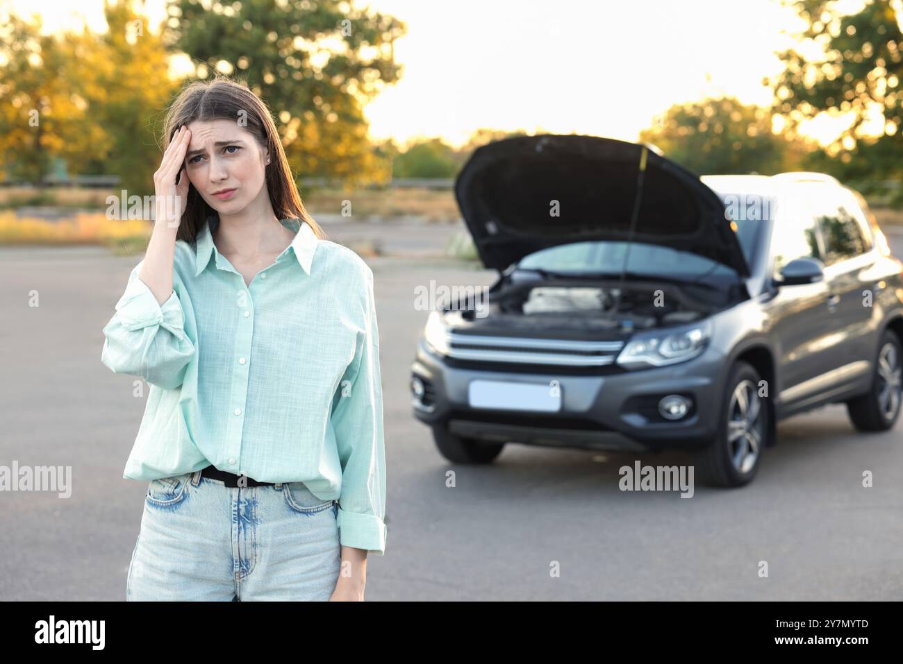Female driver standing open hood hi-res stock photography and images ...