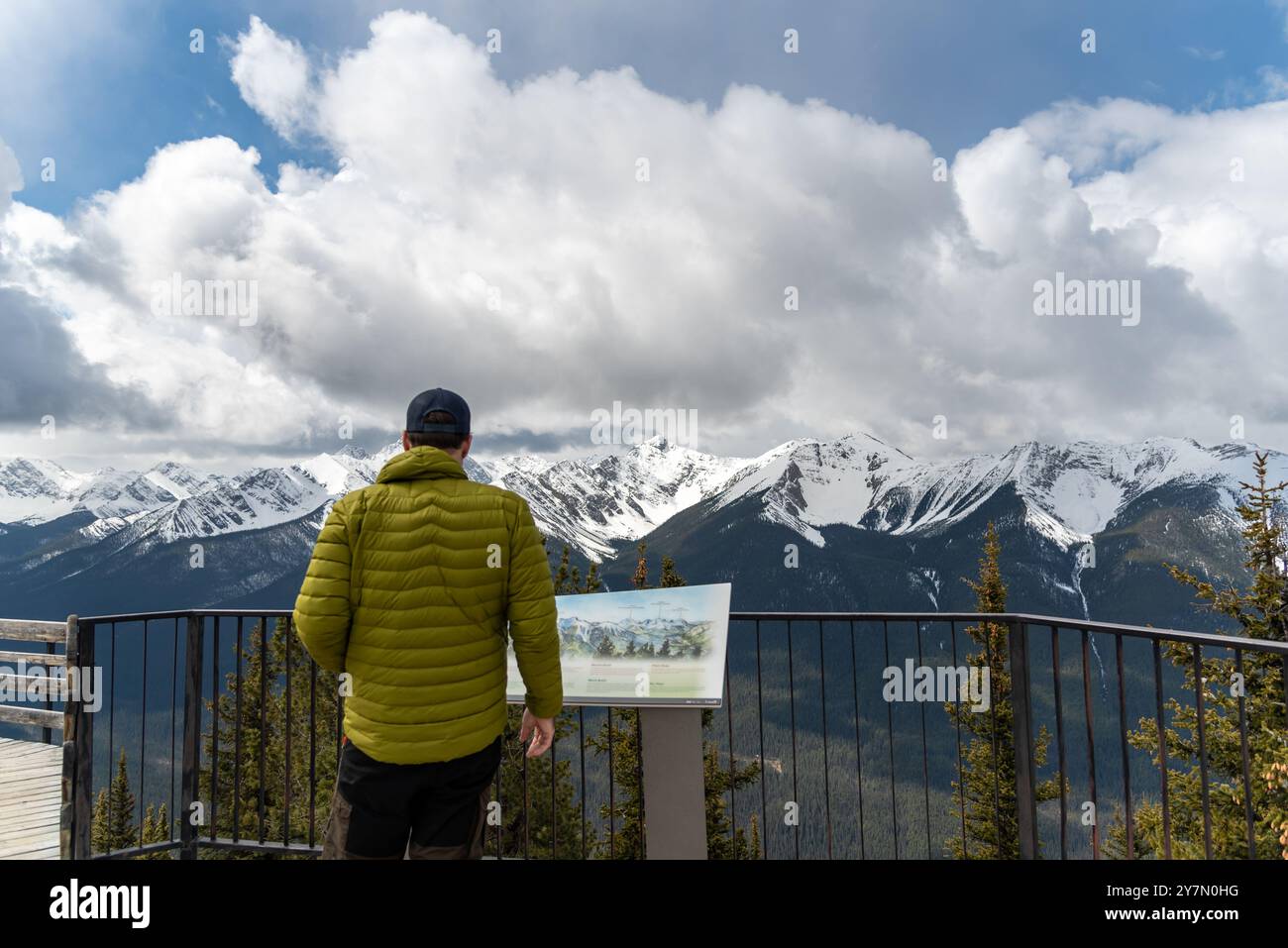 Man standing at the top of the Banff Gondola during spring time with ...