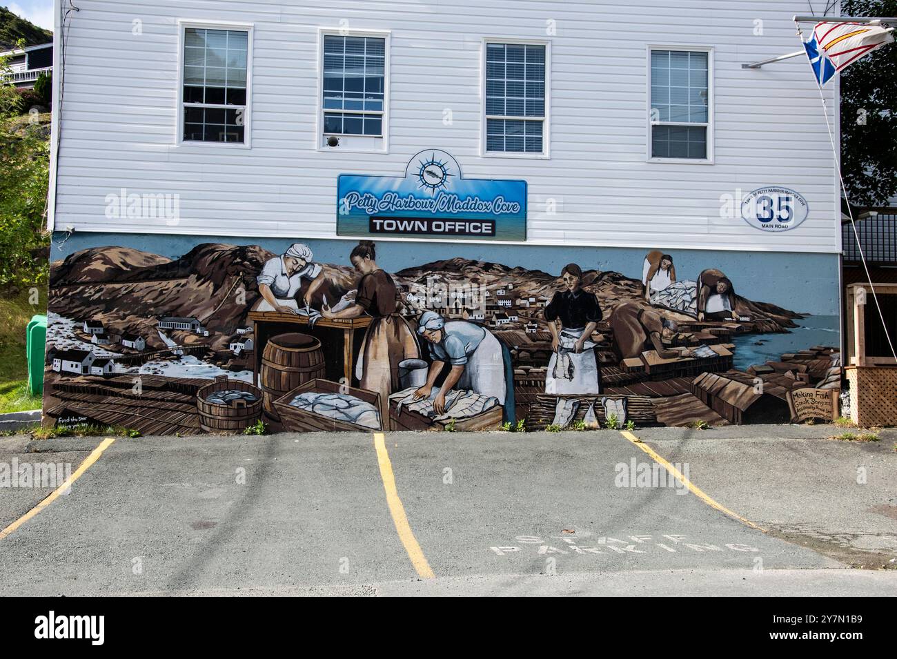 Mural of women drying cod on the beach on the town office on NL 11 in ...