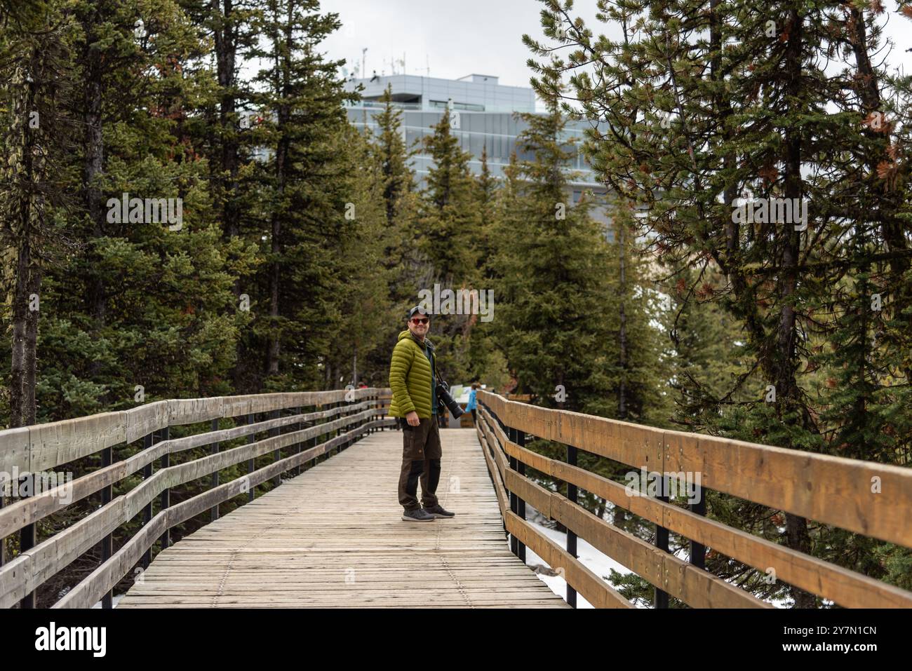 Man standing at the top of the Banff Gondola during spring time with ...