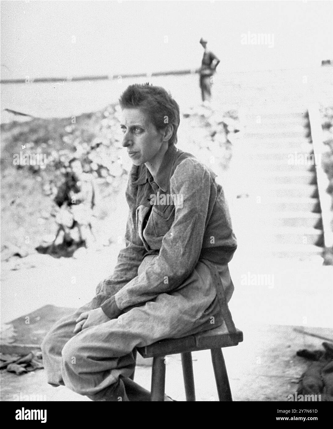 A female survivor poses outside sitting on a stool in the newly ...