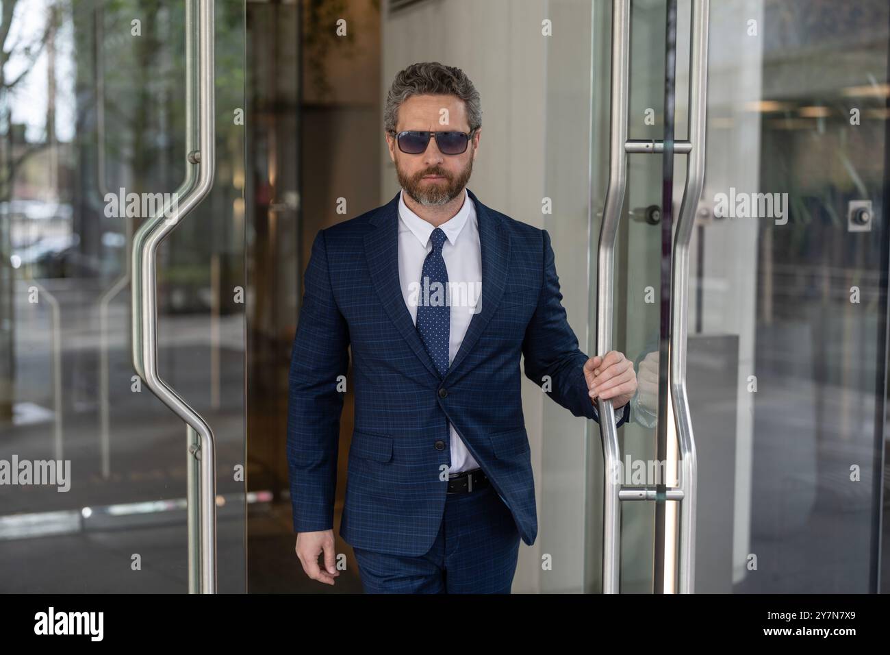 Successful businessman entering office. Mature entrepreneur at office ...