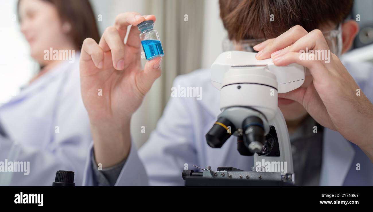Focused Laboratory Scientist Examining Chemical Sample Under Microscope ...