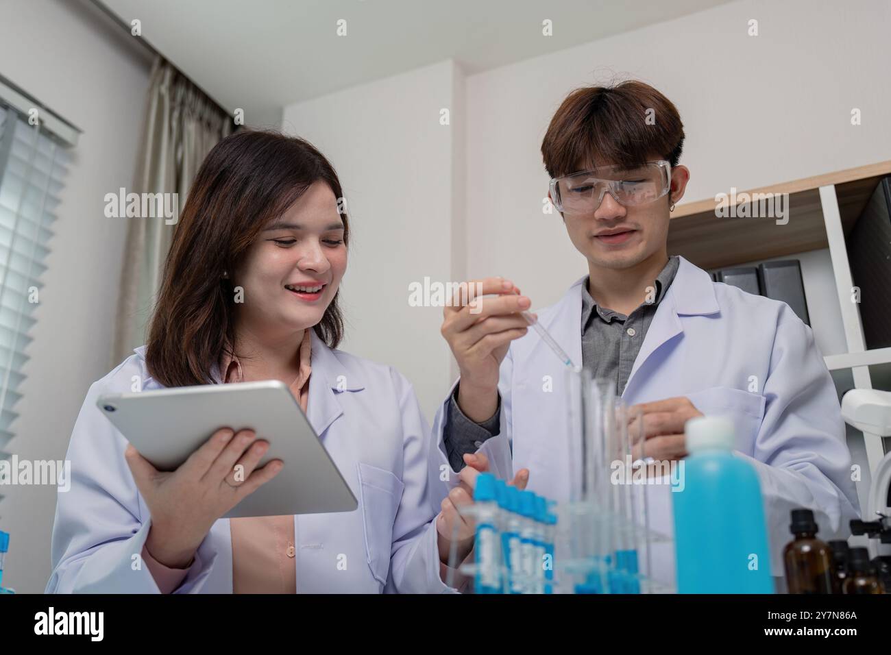 Laboratory Scientists Engaging in Chemical Experimentation with ...
