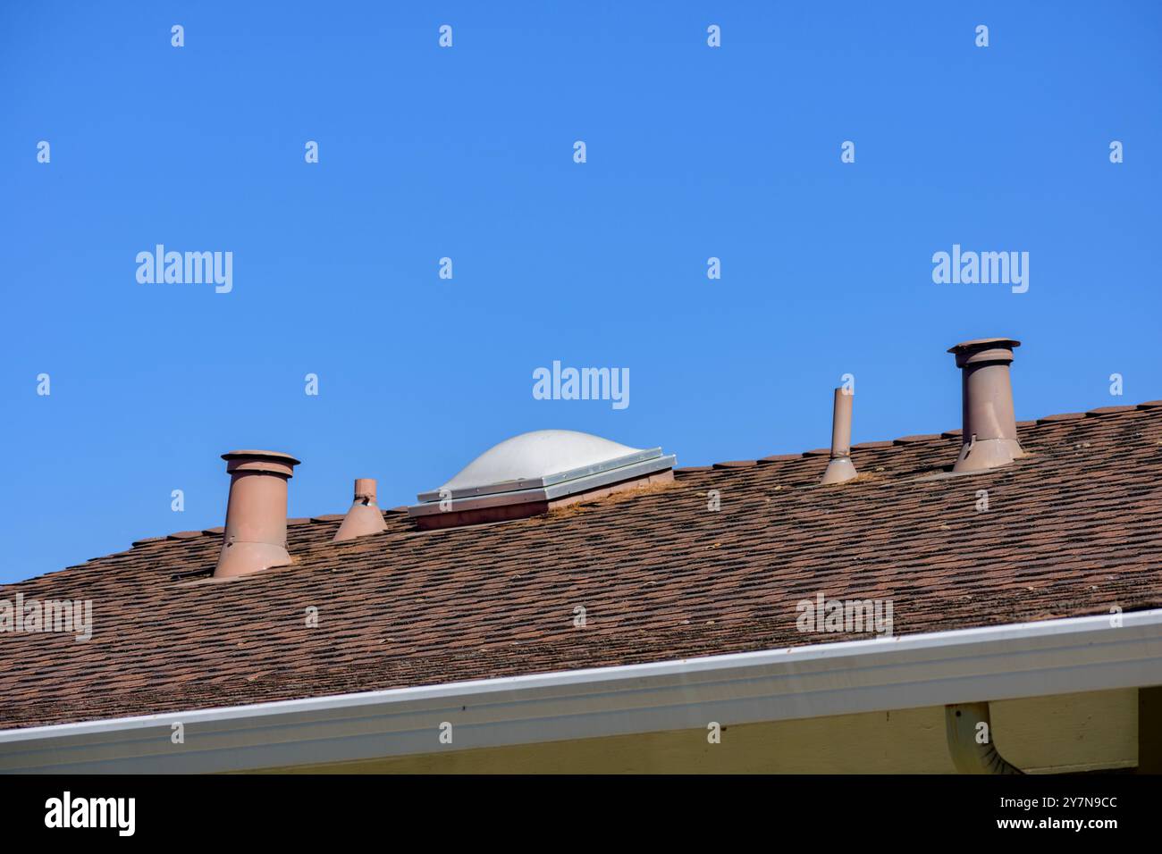 A residential rooftop with multiple vents and a dome-shaped skylight ...