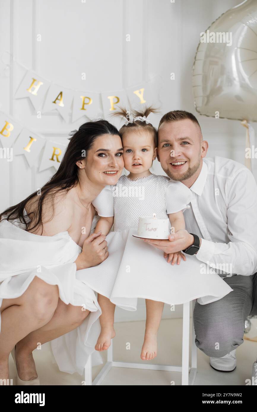 Happy family celebrating child's second birthday together Stock Photo ...
