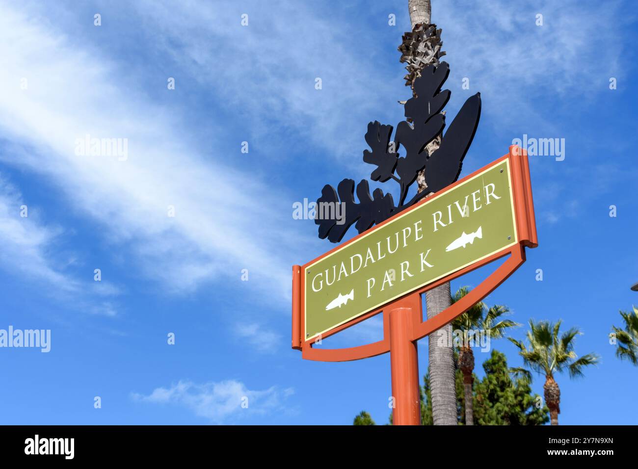 Guadalupe River Park sign with leaf and fish decorations, set under a ...