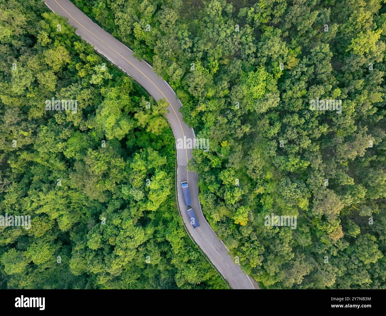 Aerial view hydrogen truck on forest highway. Sustainable ...