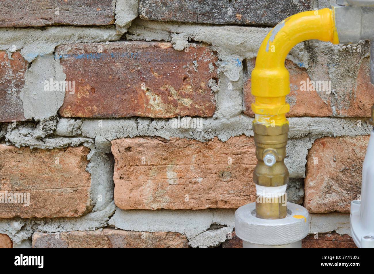 yellow gas pipe meter on the wall Stock Photo - Alamy