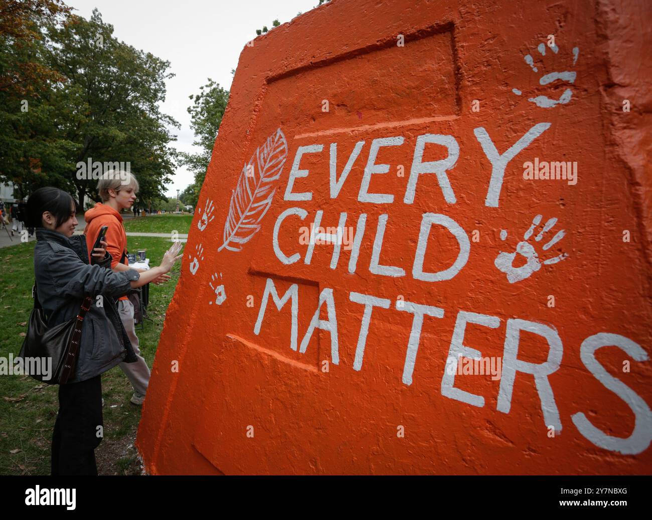 Vancouver, Canada. 30th Sep, 2024. A woman presses her handprint on a ...