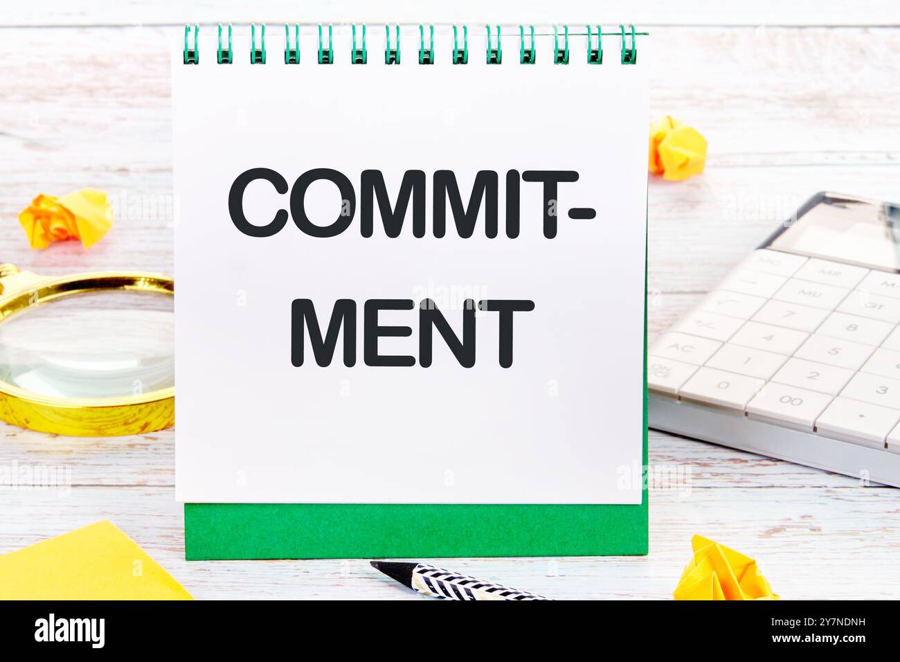 COMMITMENT Word Written on a blank sheet of a desktop notebook Stock ...