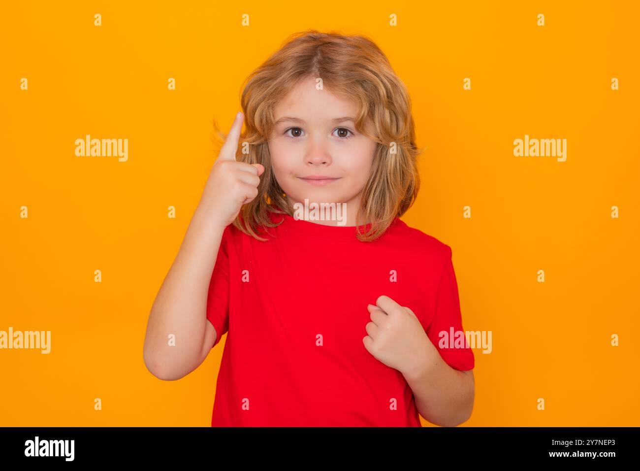 Child have idea on yellow isolated background. Child pointing up finger ...