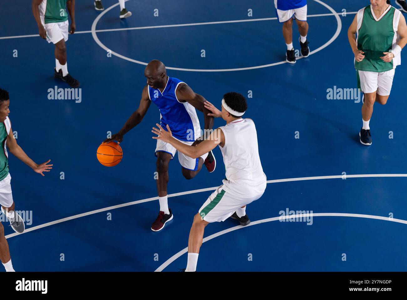 Playing basketball, athletes in action on court during competitive game ...