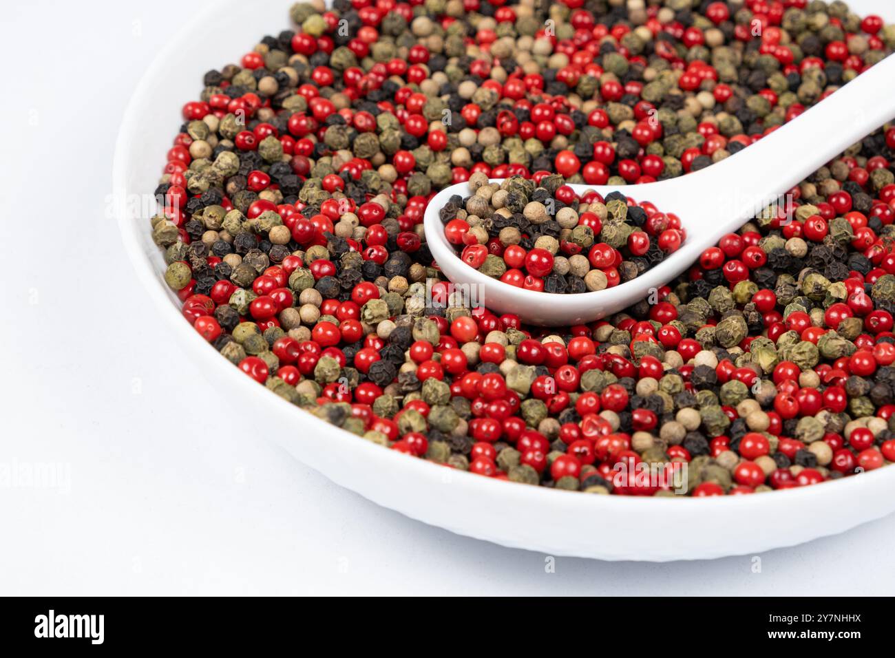 Different varieties of peppercorns, red, green, black and white peppers ...