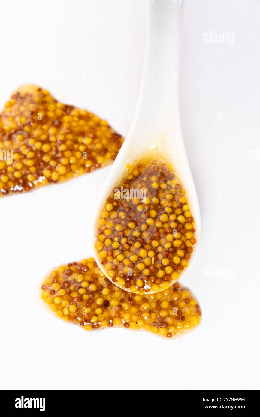 Traditional French Dijon mustard in a spoon on a white background Stock ...
