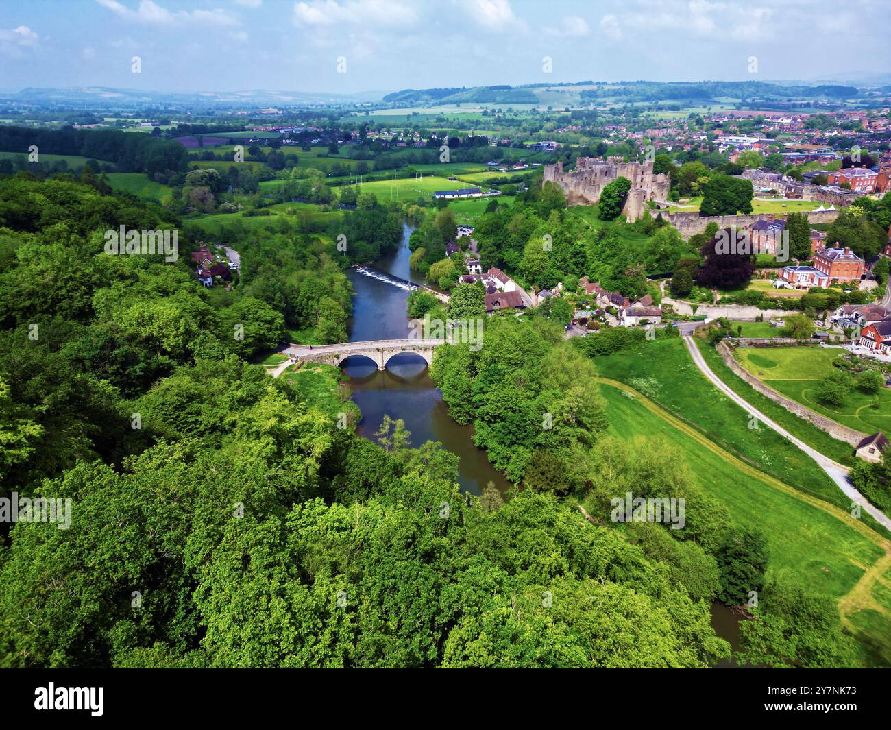 An Aerial view of Ludlow, Shropshire with Ludlow Castle, a stone bridge ...