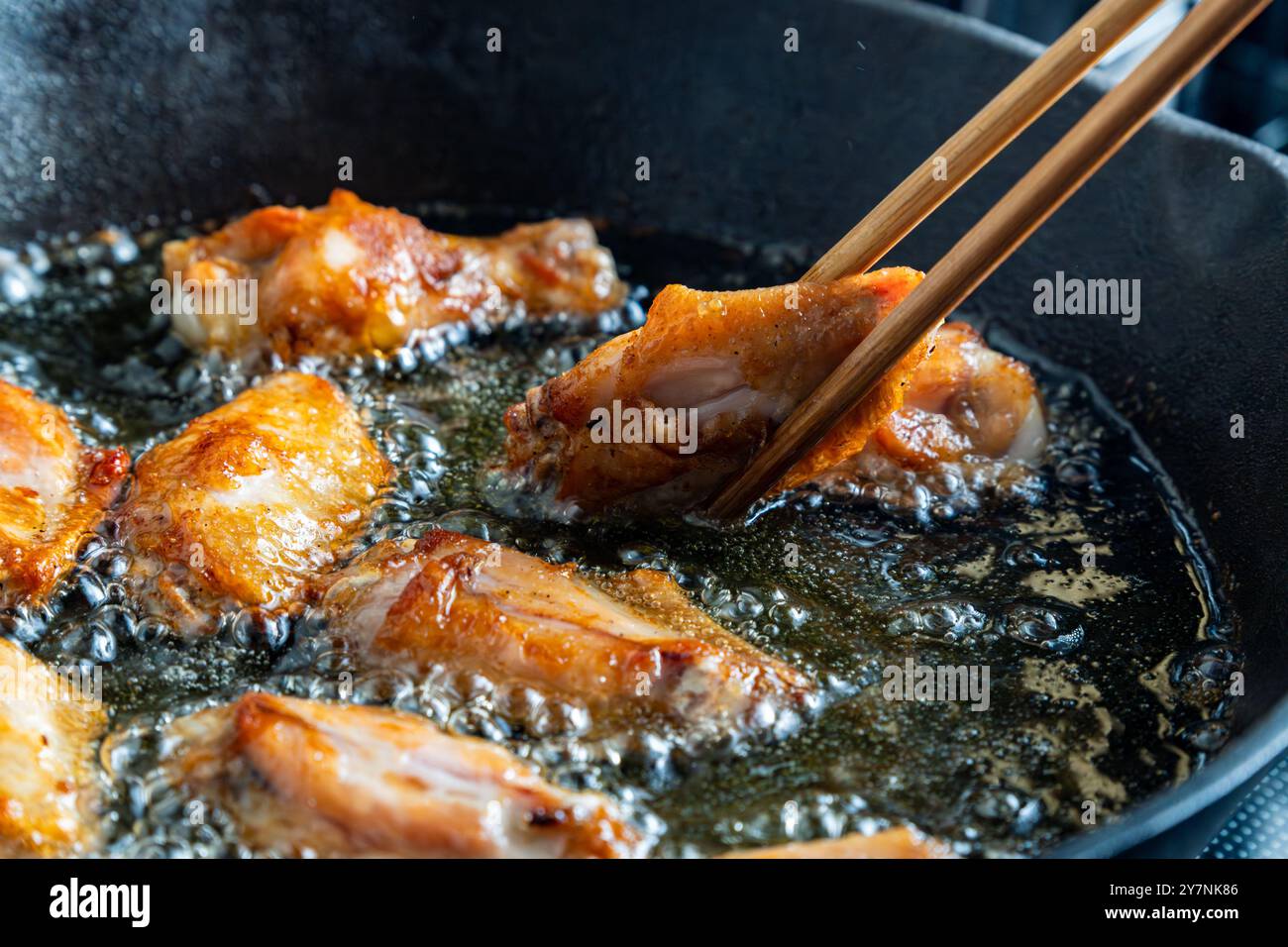 chicken wing fried until golden brown in bubbling hot vegetable oil ...