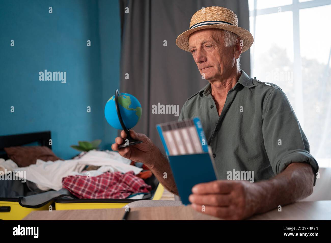 traveler tourist elderly man in hat at home. Passenger traveling abroad ...
