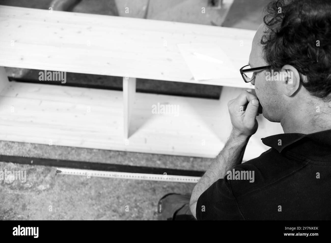 Black and white image of A carpenter is thinking about his new project ...
