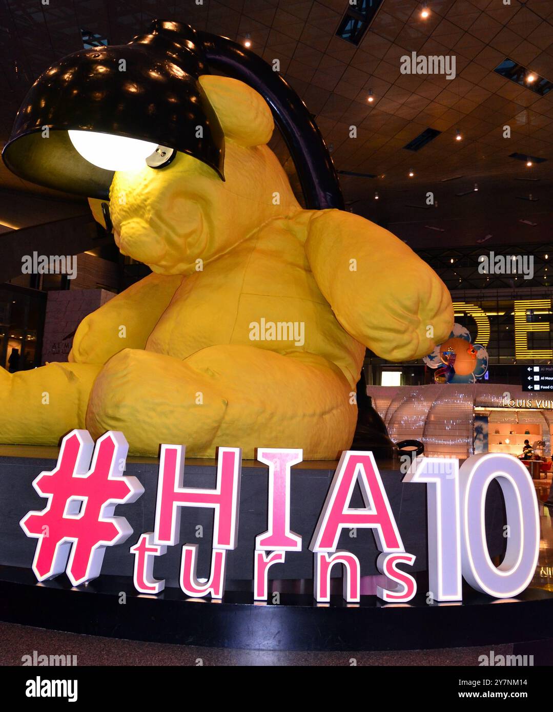 Illuminated signs below the iconic large bear statue at Hamad ...
