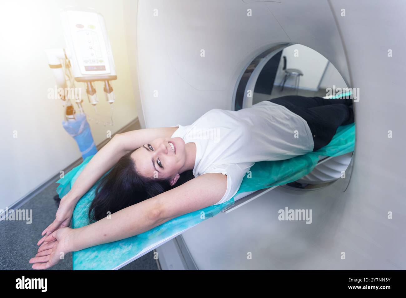 beautiful woman lying on ct scanner bed during tomography test in ...