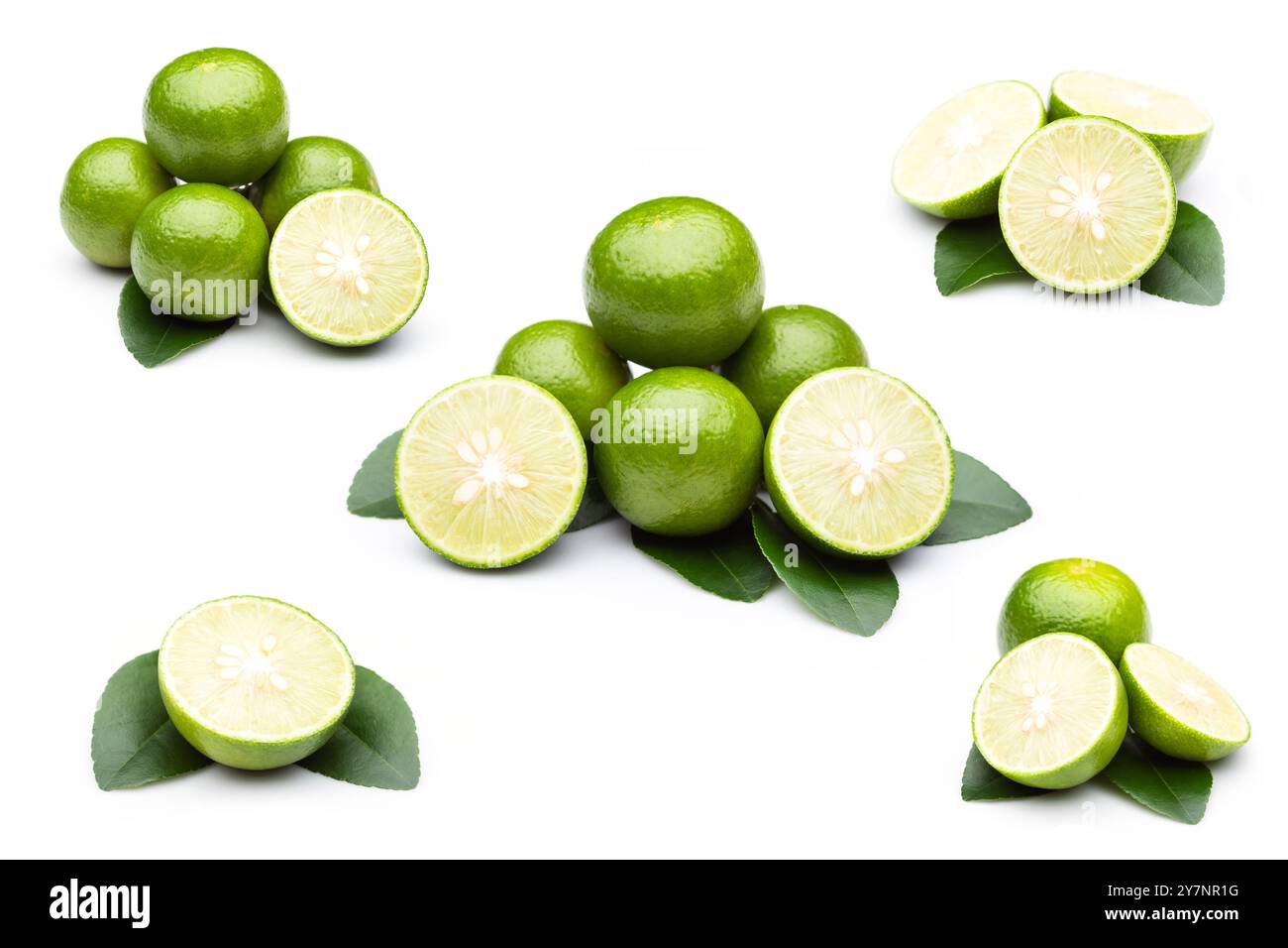 A Thai lime, halved and whole, is placed on a white background. The ...
