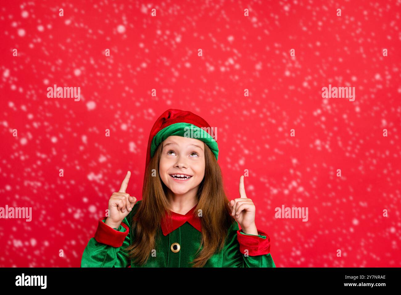 Portrait of cute elf in green hat cap having long haircut showing ads ...