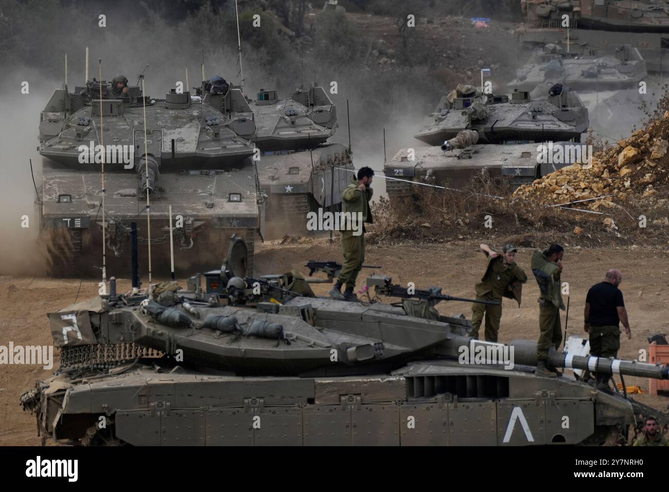 Israeli army tanks maneuver in a staging area in northern Israel near ...