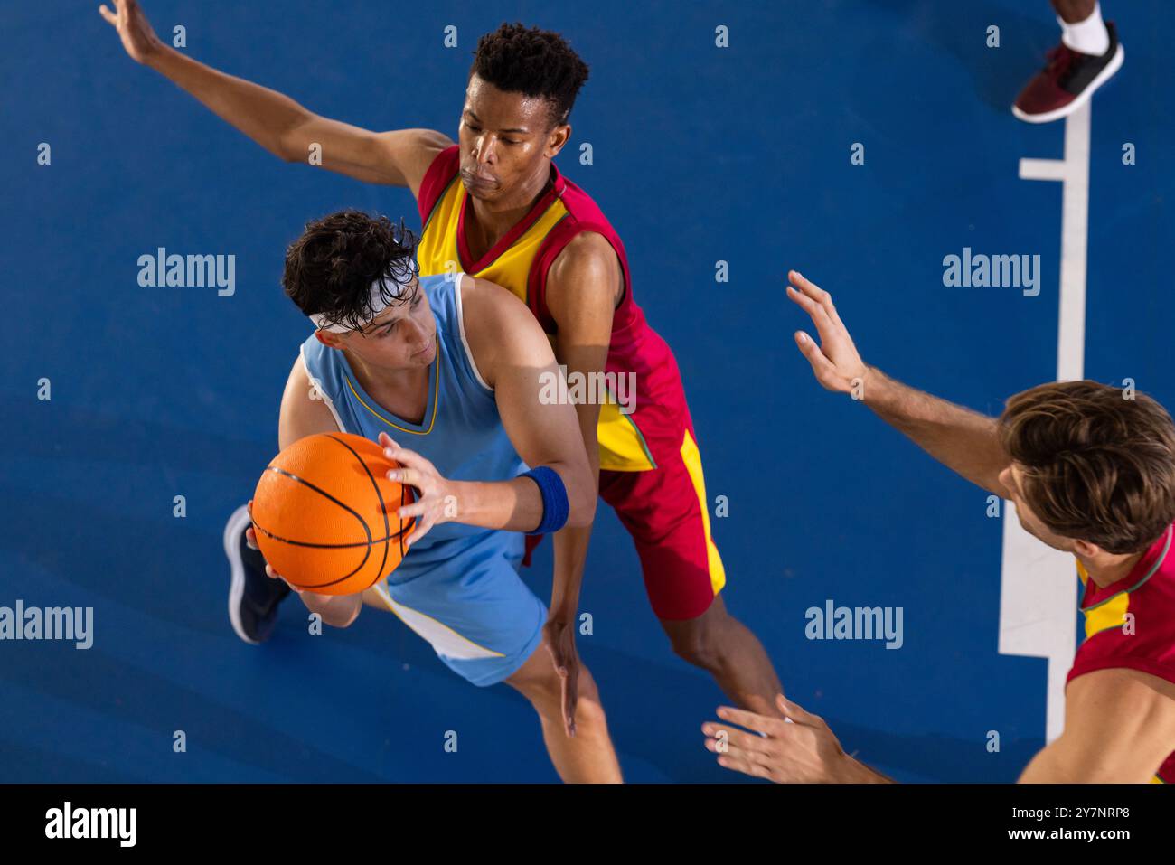 Playing basketball, athletes in action on court, competing for ball ...