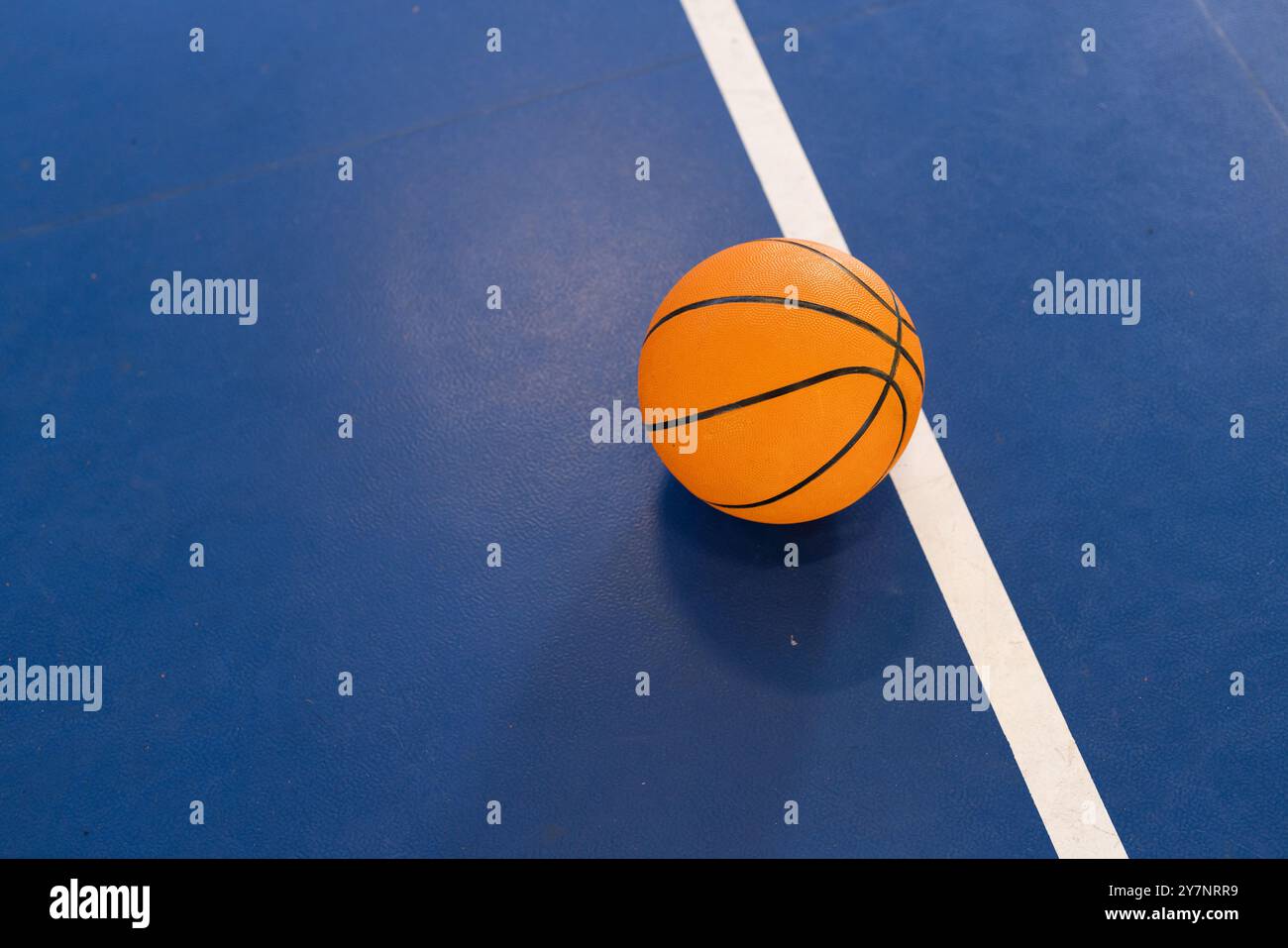 Basketball resting on blue hi-res stock photography and images - Alamy