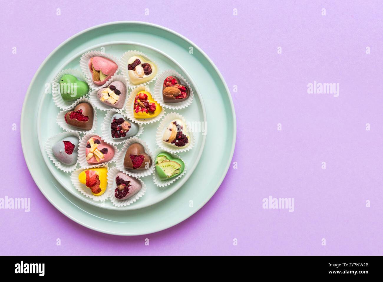 Plate with different chocolate on colored background. Assortment of ...