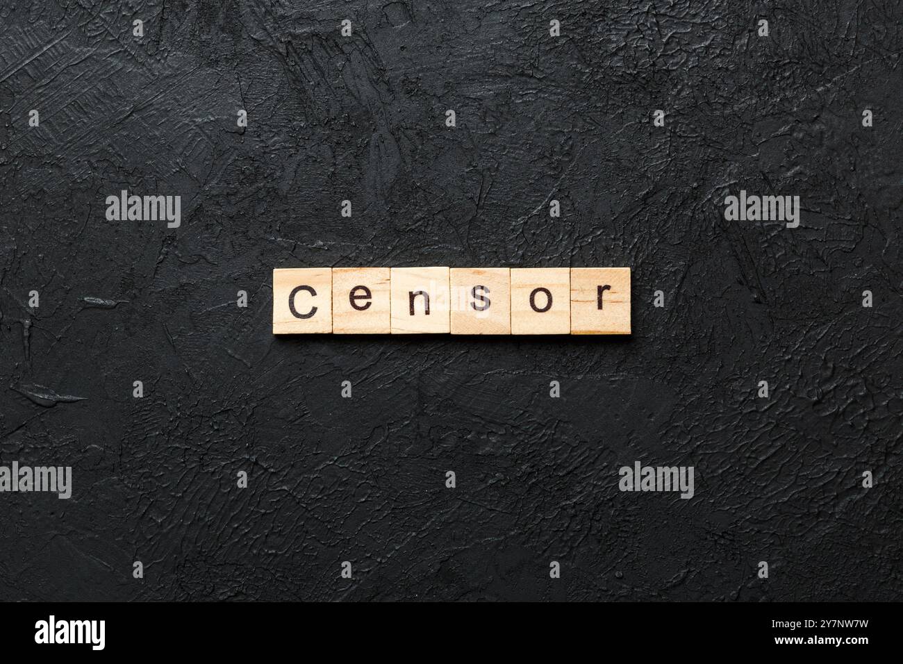 Censor word written on wood block. Censor text on cement table for your ...