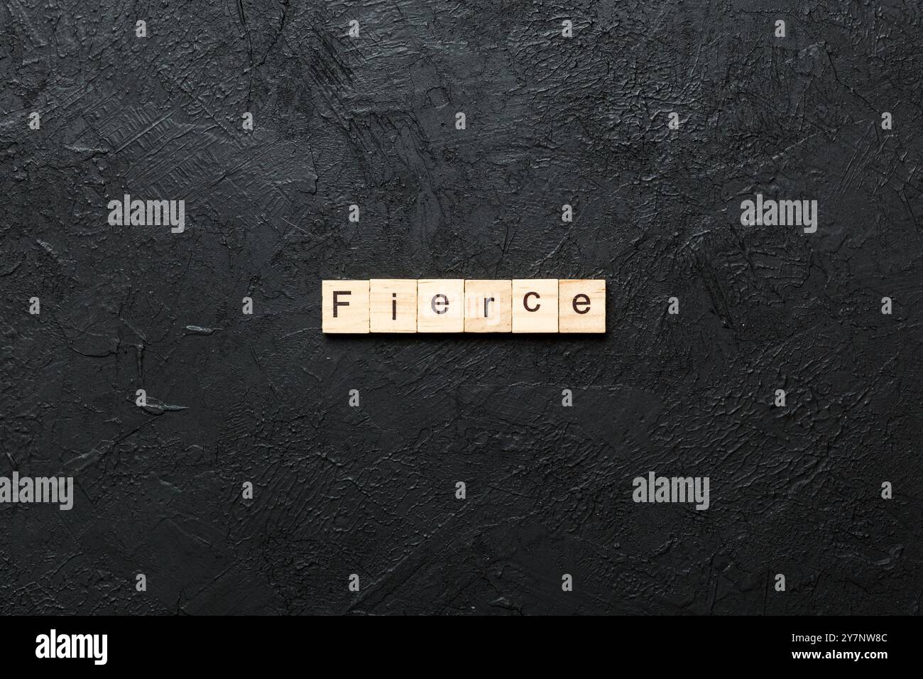 Fierce word written on wood block. Fierce text on cement table for your ...