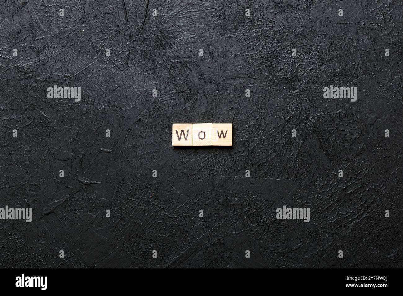 WOW word written on wood block. WOW text on cement table for your ...