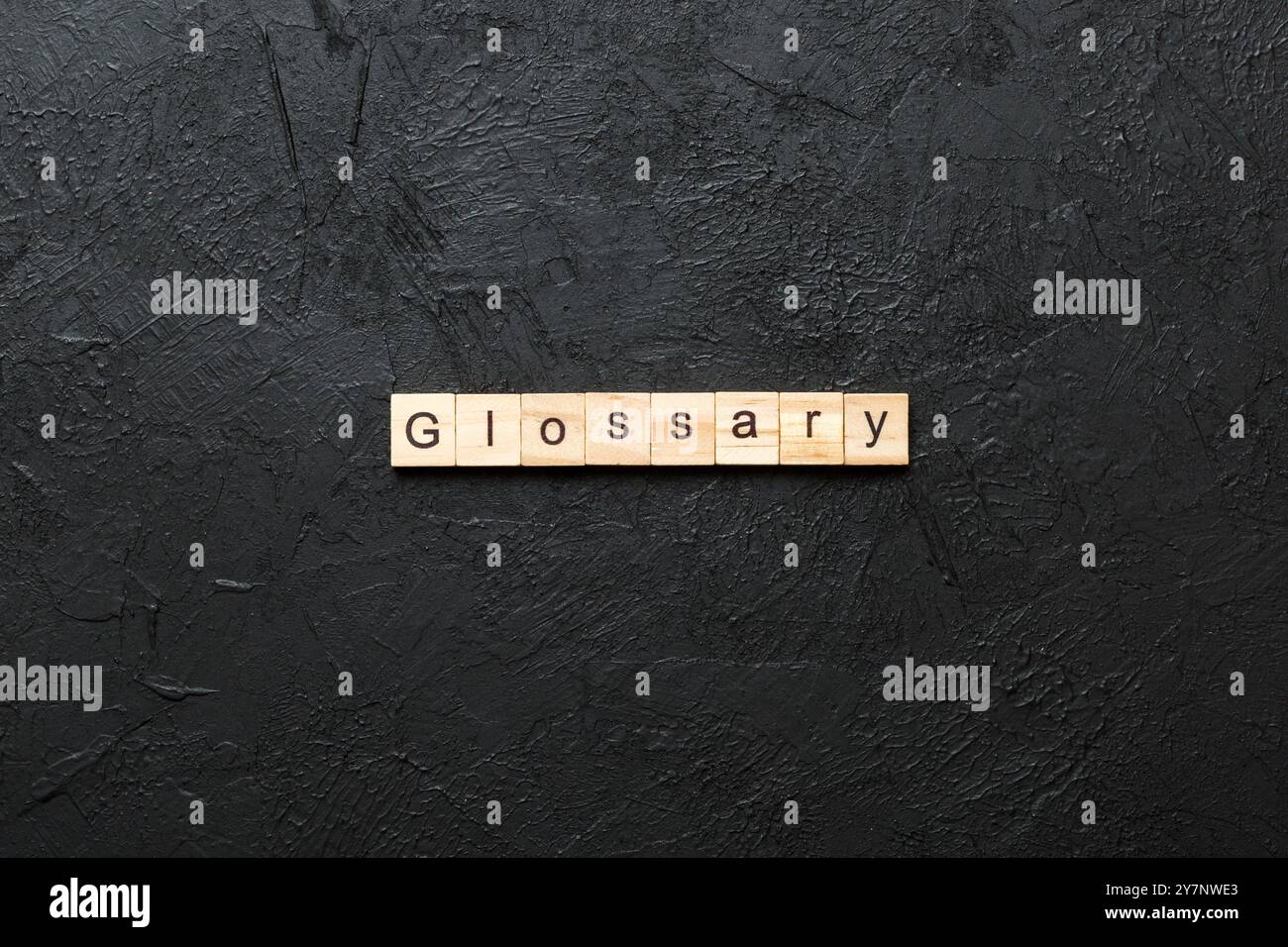 glossary word written on wood block. glossary text on table, concept ...