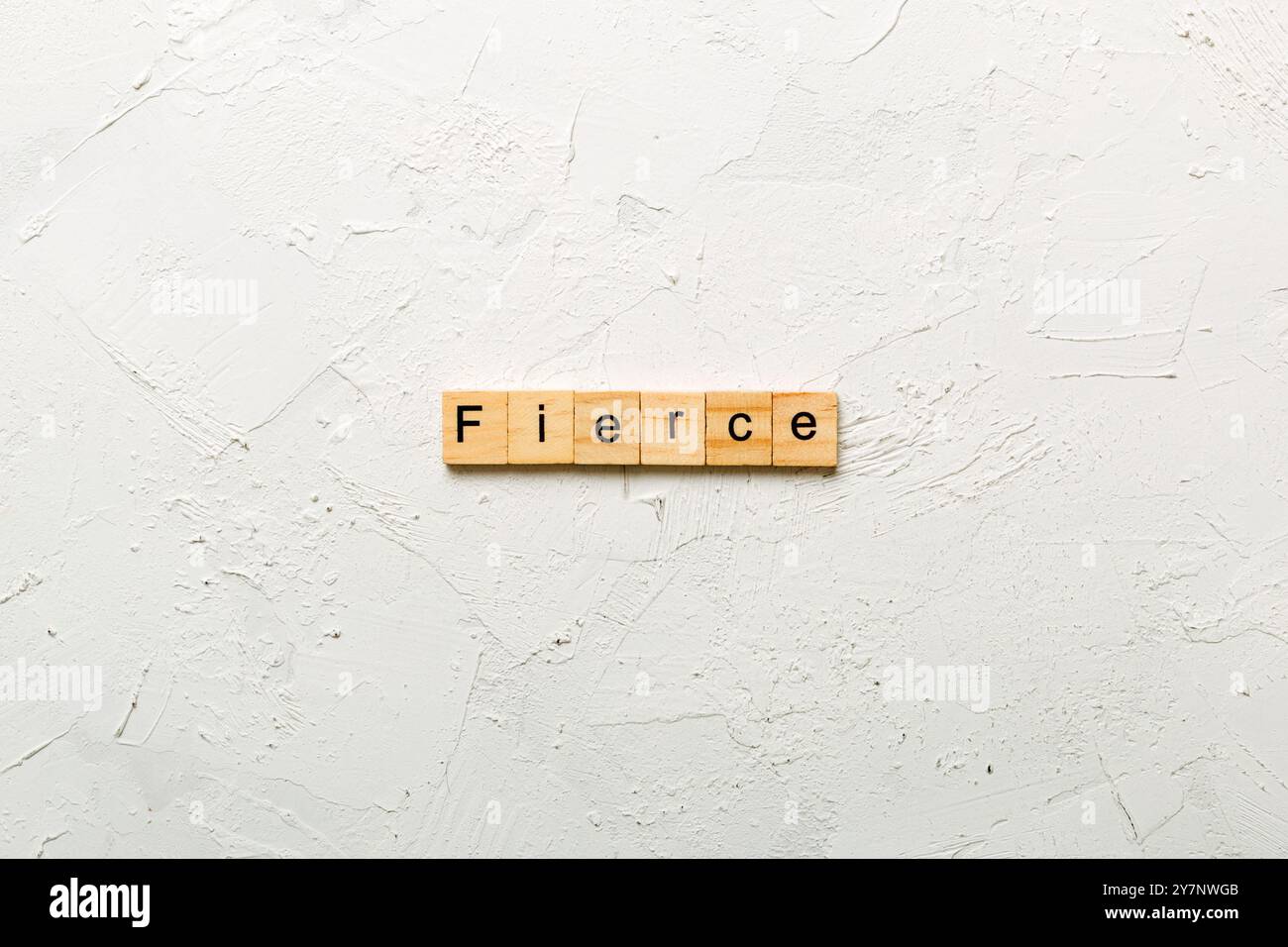 Fierce word written on wood block. Fierce text on cement table for your ...