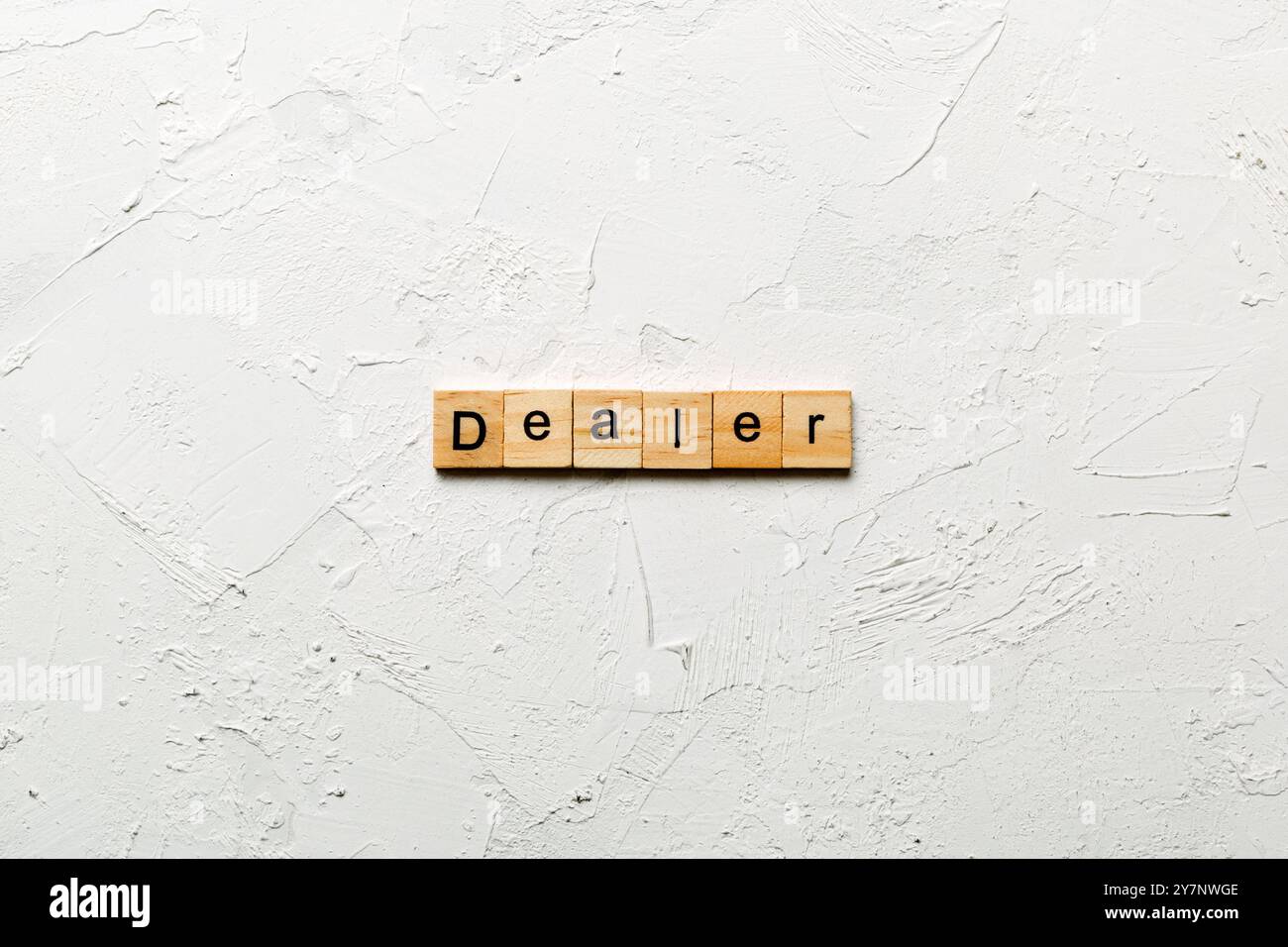 Dealer word written on wood block. Dealer text on cement table for your ...