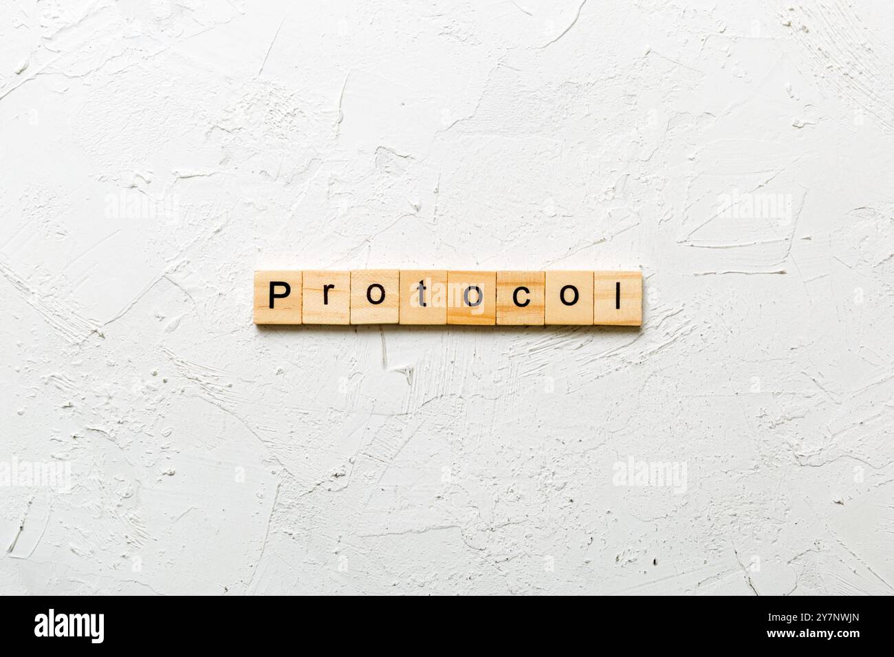 PROTOCOL word written on wood block. PROTOCOL text on cement table for your desing, concept ...
