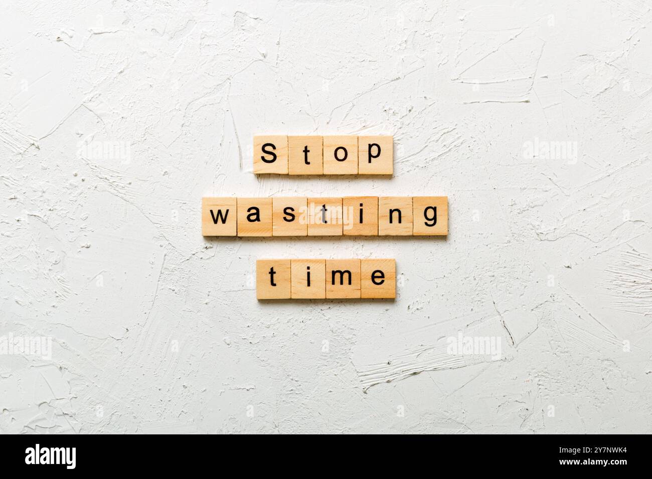 Stop wasting time word written on wood block. Stop wasting time text on ...