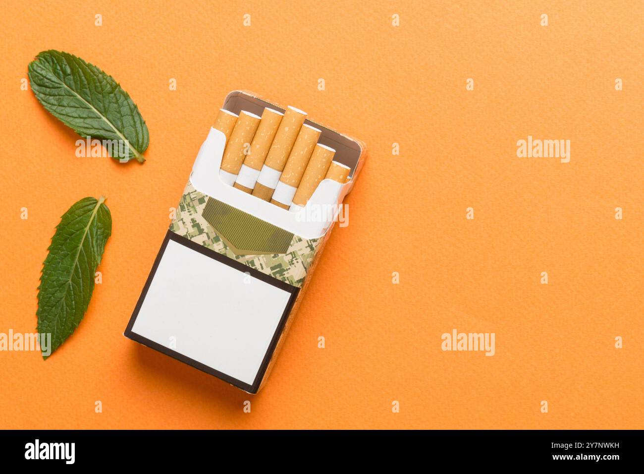 Pack of menthol cigarettes and fresh mint on colored table, Menthol ...